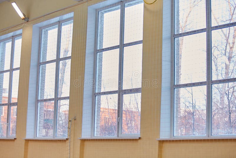 Large Windows in the School Gym, Covered with Netting from Ball Strikes ...