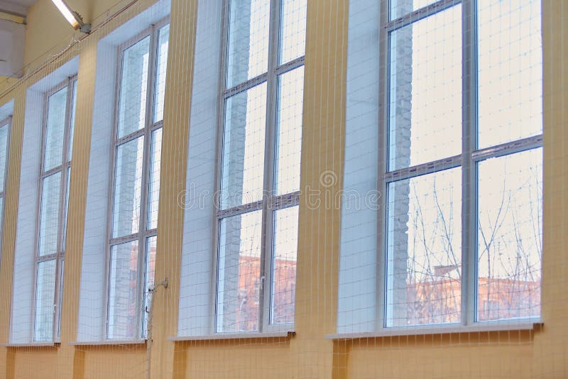 Large Windows in the School Gym, Covered with Netting from Ball Strikes ...