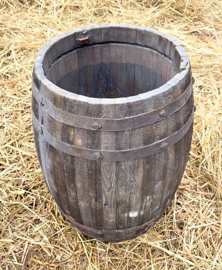 A Large Wooden Barrel Sits on a Field of Dry Grass Stock Image - Image ...