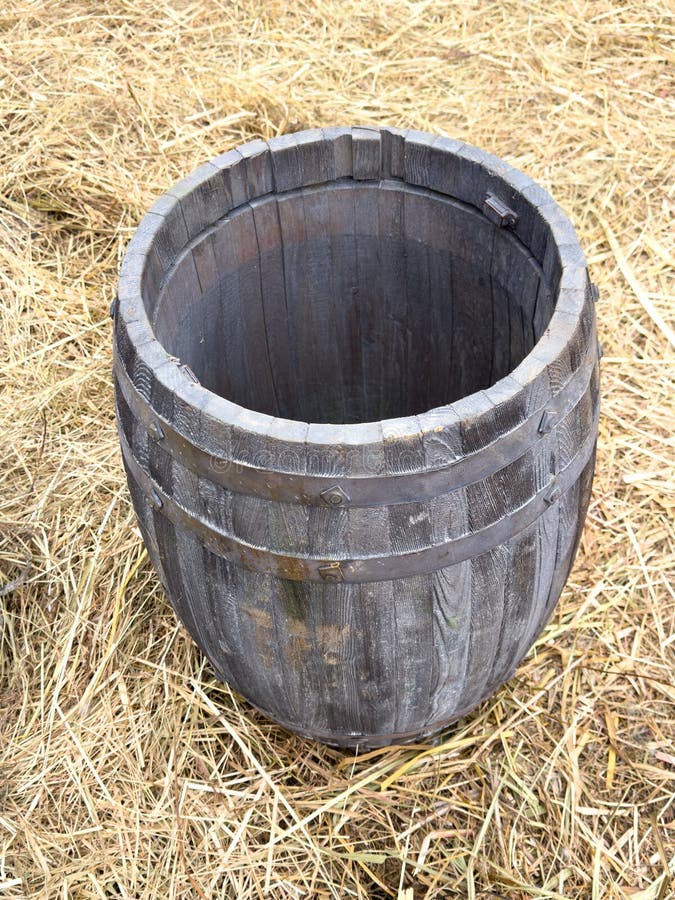 A Large Wooden Barrel is Sitting on a Field of Hay Stock Photo - Image ...