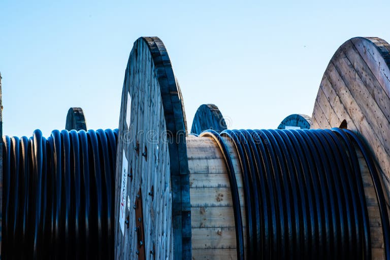 Large Wooden Cable Drums with Black Cable.. Stock Photo - Image of line ...