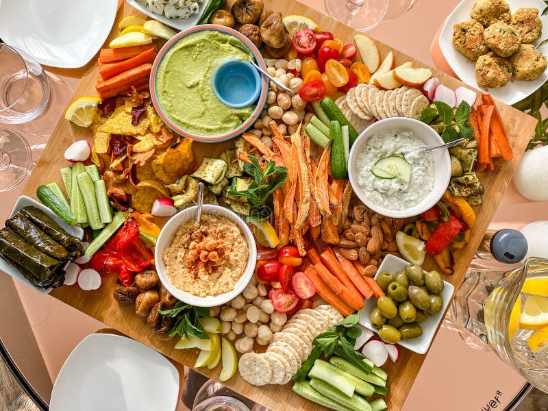 Large Wooden Platter Filled with Vegetables, Dips, Crackers, and ...