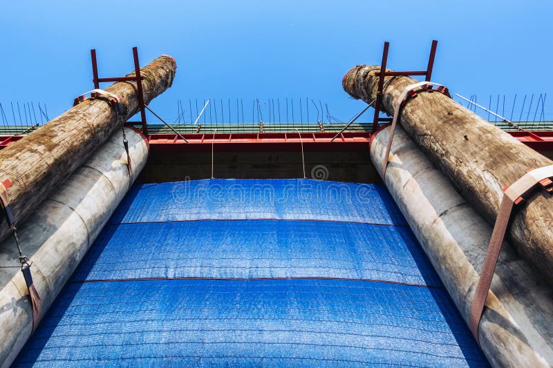 Large Wooden Posts Attached To Concrete Posts To Support the Strength ...