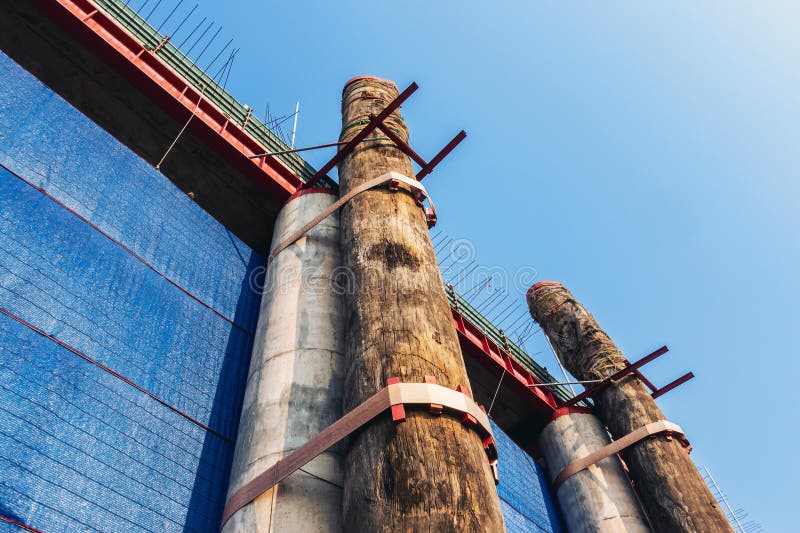 Large Wooden Posts Attached To Concrete Posts To Support the Strength ...