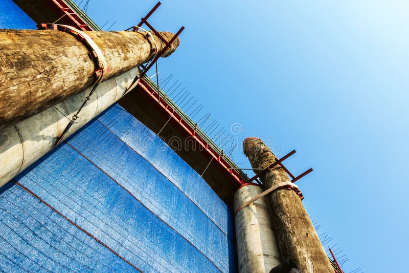 Large Wooden Posts Attached To Concrete Posts To Support the Strength ...