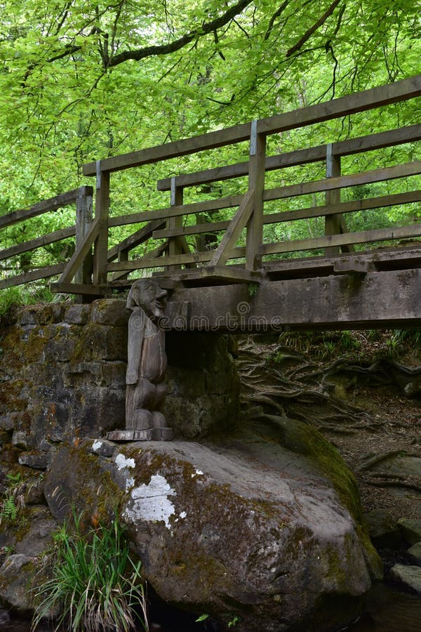 Large Wooden Troll Under a Bridge in the Woods Stock Image - Image of ...