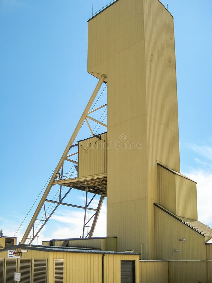 A Large Yellow Building with a Sign on it Stock Photo - Image of ...