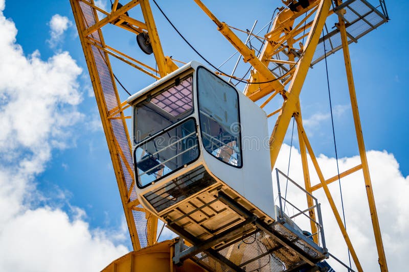 A Large Yellow Crane Stands Out Against a Bright Blue Sky Stock Photo ...