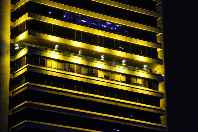 Large Yellow Illuminated Downtown Building at Night Stock Photo - Image ...