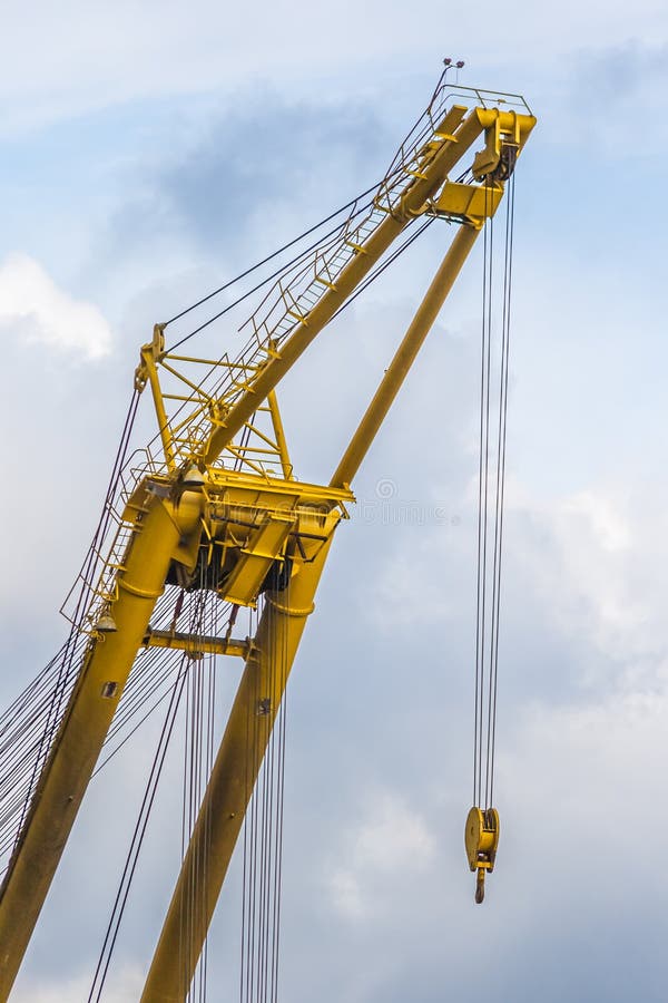 Large Yellow Industrial Crane with Cables Against a Cloudy Sky Stock ...