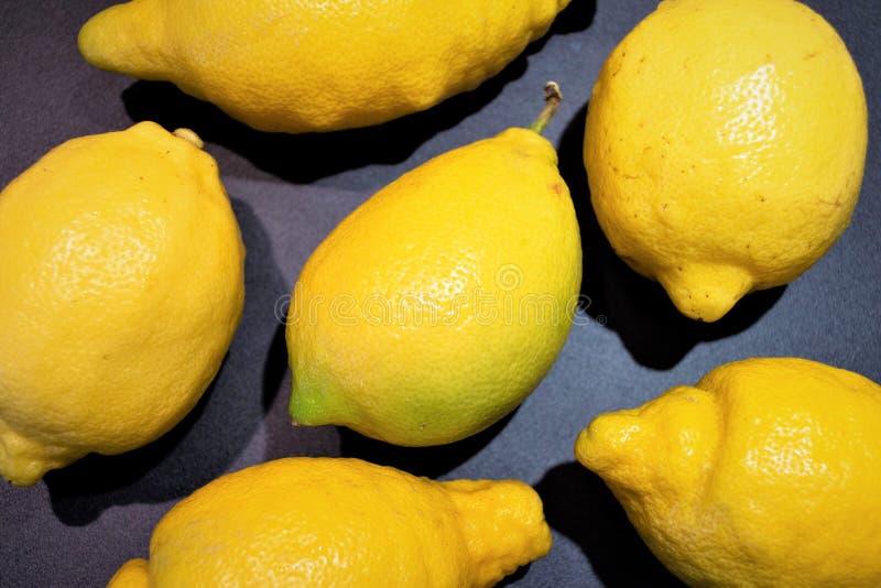 Large Yellow Lemons of Different Shapes on a Black Graphite Stock Image ...