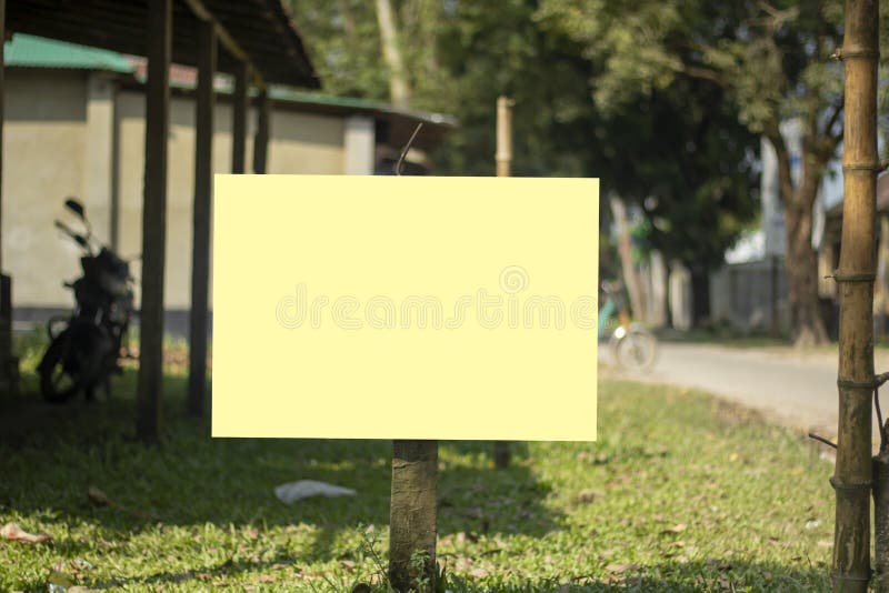 A Large White Sign Board Hanging with a Pole and the Background Blur ...