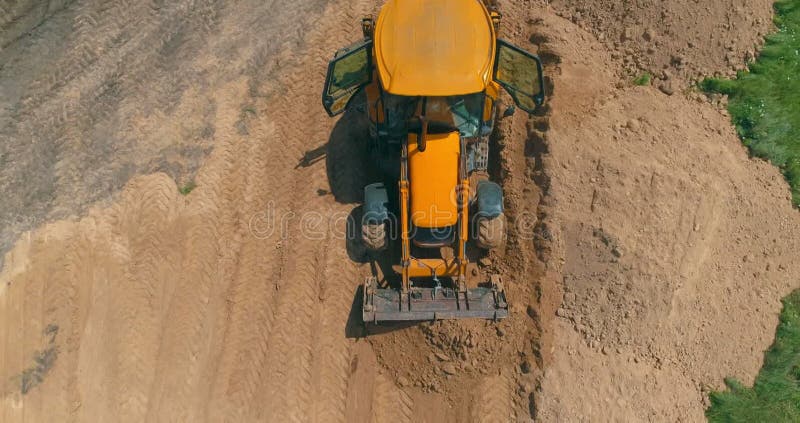 Large Yellow Tractor on a Construction Site. Working Process at a ...
