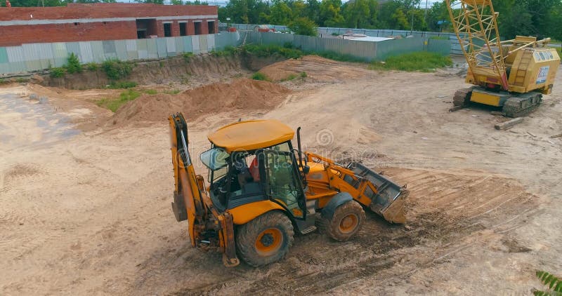 Large Yellow Tractor on a Construction Site. Working Process at a ...