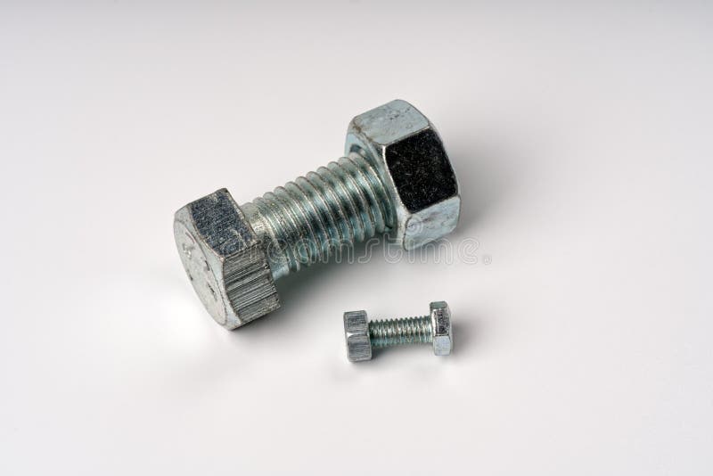The Largest and Smallest Bolts with Nuts on a White Background. Stock ...