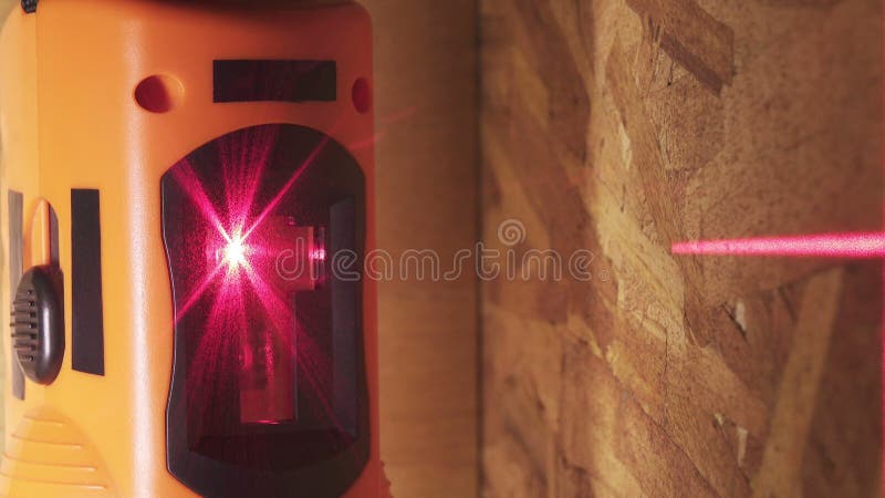 Laser Construction Level in Work and a Marking His Beams on a Wall ...