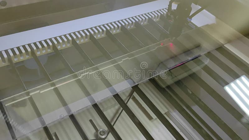 A Laser Cutter Cuts a Workpiece Made of Transparent Plastic Stock Video ...