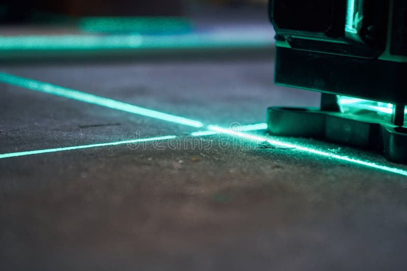 Laser Level Measuring Tool with Visible Green Laser Beam on Wall at ...