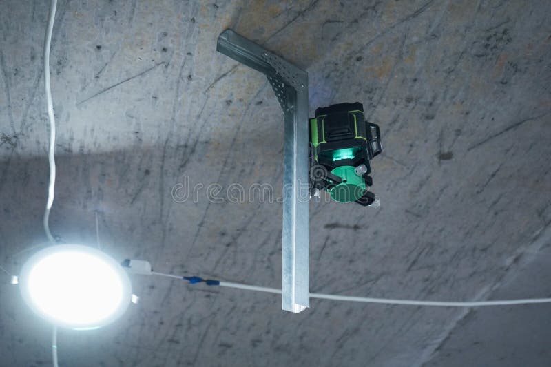 A Laser Level is Mounted on the Unfinished Ceiling, Ready for Precise ...