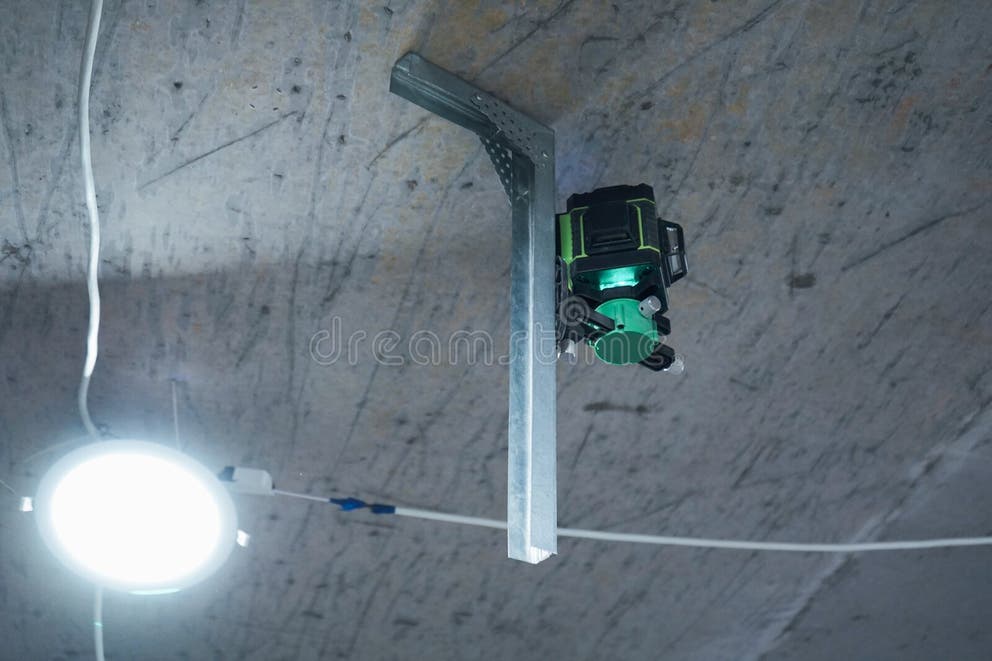 A Laser Level is Mounted on the Unfinished Ceiling, Ready for Precise ...