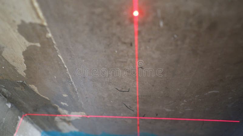 Laser Level Projecting Red Crosshairs Onto Damaged Wall during Home ... Laser Level Projecting Red Crosshairs Onto Damaged Wall during Home ...