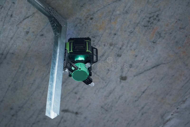 The Laser Level Projects a Bright Green Line Onto a Smooth White ...