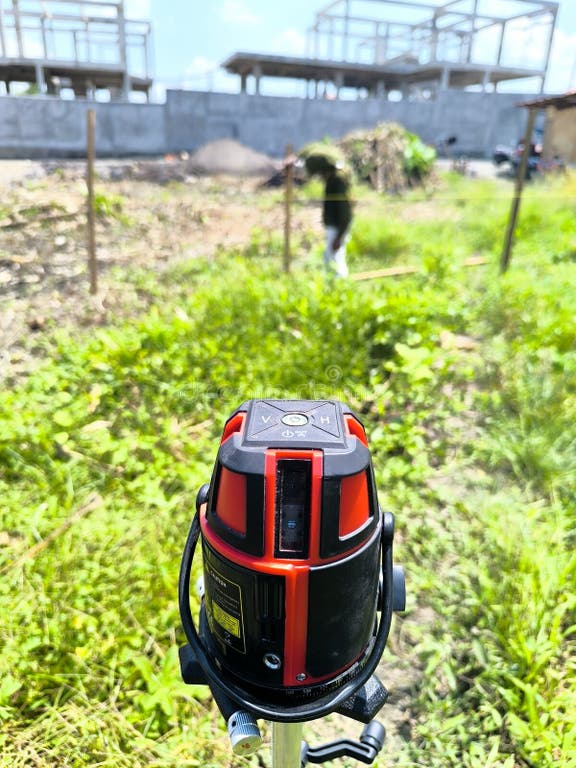Laser Meter Standing in the Middle of a Building Project Site with a ...