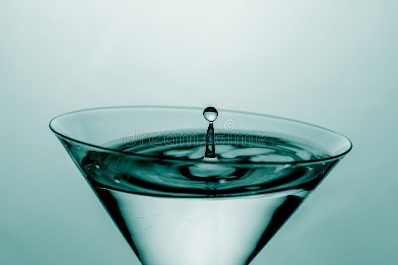 Last Drop of the Drink Falls into a Martini Glass Stock Image - Image ...