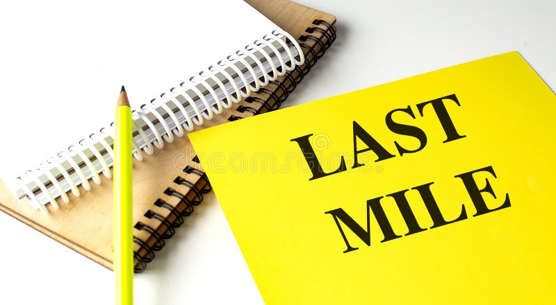 LAST MILE Text on Yellow Paper with Notebooks Stock Image - Image of ...