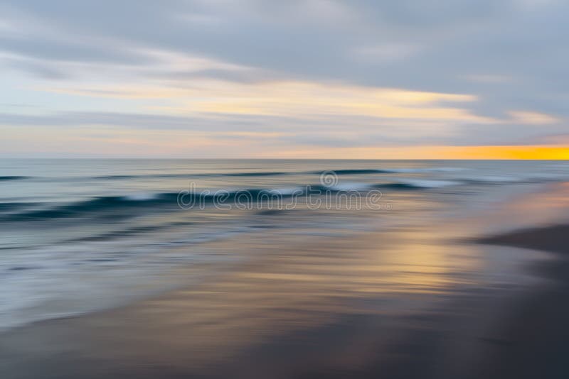 Last Rays of the Sunset Cast a Vibrant Glow Over the Blurred Motion of ...