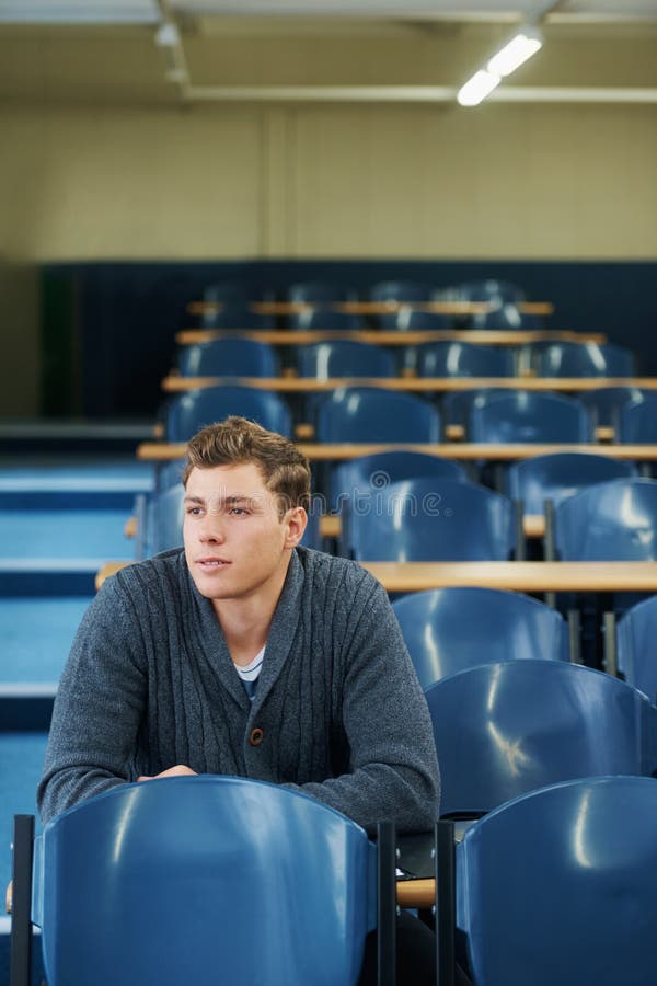 The Last Student in the Lecture Hall. a Young Man Sitting Alone in a ...