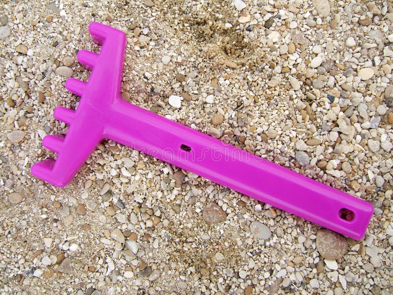 Lastic Toy Sand Rake on Beach Stock Photo - Image of summertime, sand ...