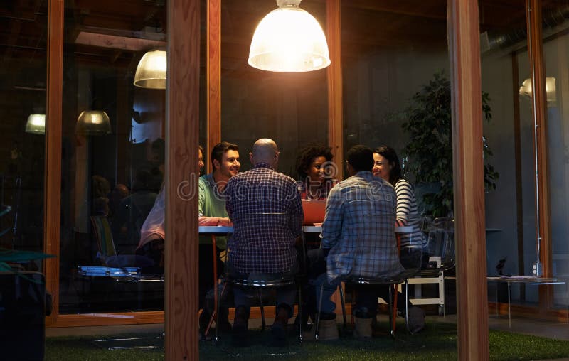 Late Night Meeting Around Table in Design Office Stock Photo - Image of ...