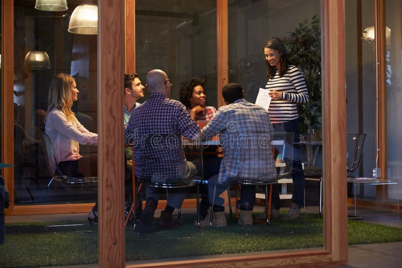 Late Night Meeting Around Table in Design Office Stock Photo - Image of ...