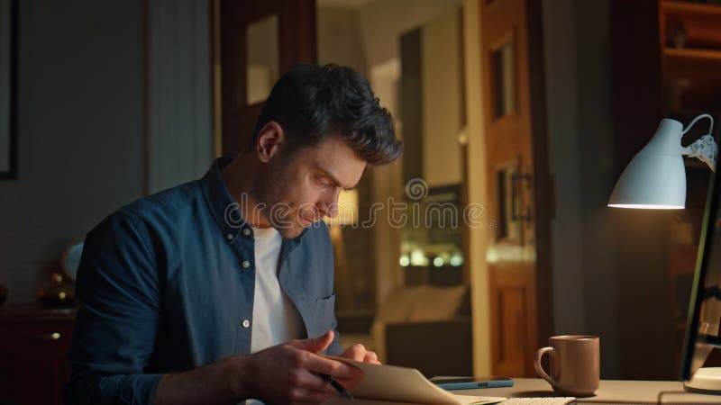 Late Student Flipping Notebook Watching Webinar at Evening Workplace ...