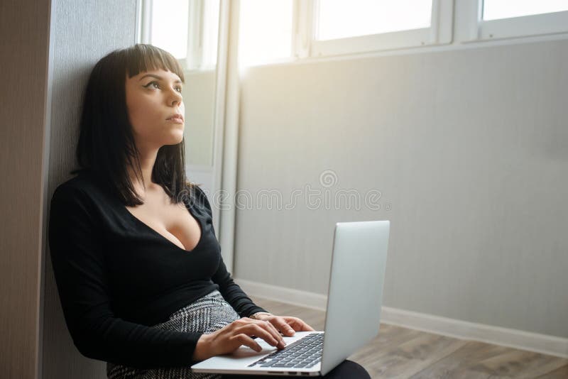 Hot Brunette In Office Outfit Sitting On The Floor And Working On