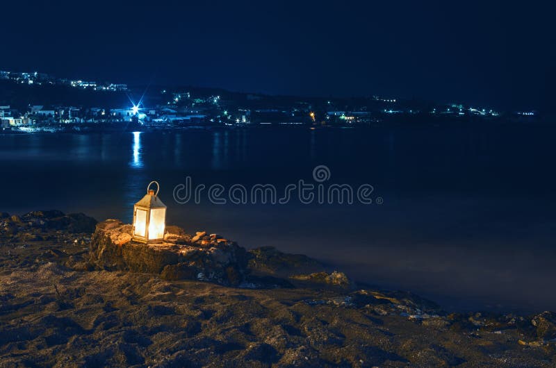 Latern on beach at night stock photo. Image of ground - 72844962