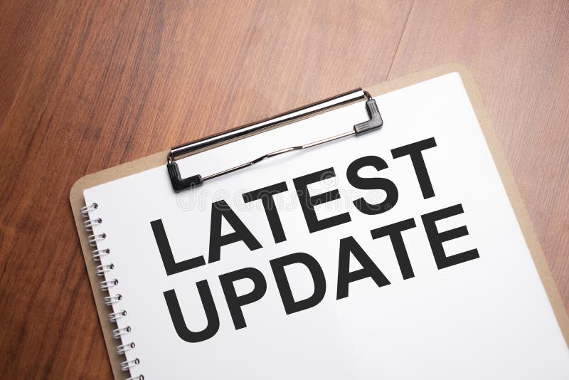 Latest Update Text on White Paper on the Wood Table Stock Photo - Image ...