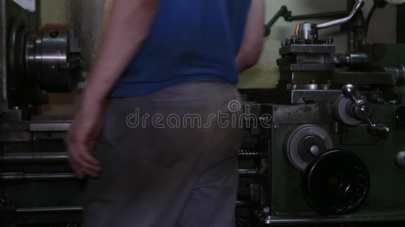 Machine Operator Operates on Old Lathe Machine. Turning Lathe in Action ...