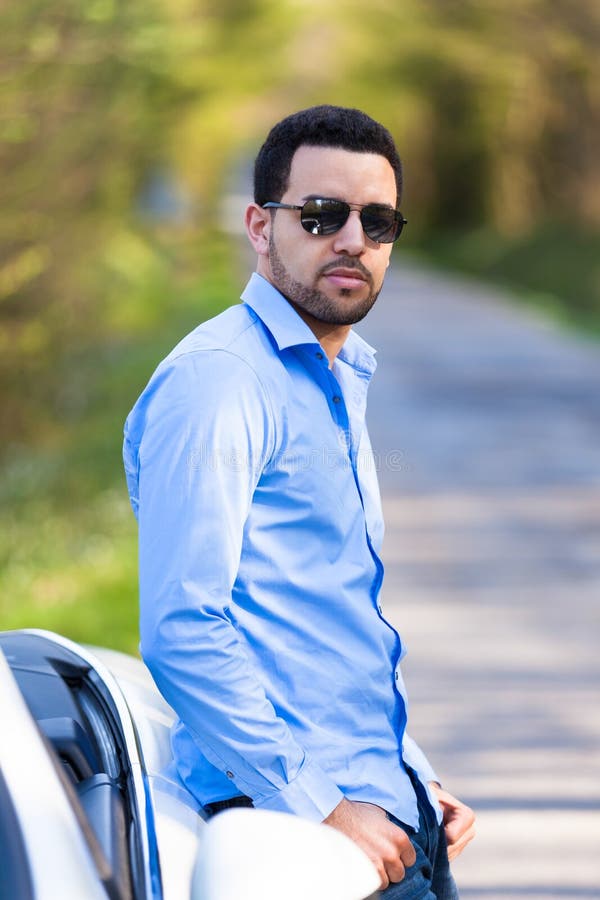 Latin American Driver Seated on the Side of His New Car Stock Image ...