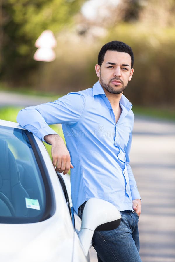 Latin American Driver Seated on the Side of His New Car Stock Photo ...