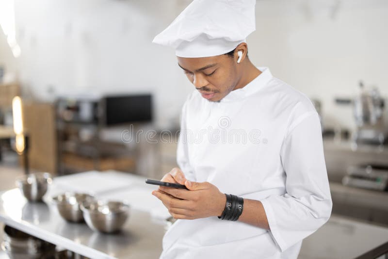 Latin Chef with Phone in Professional Restaurant Kitchen Stock Photo ...