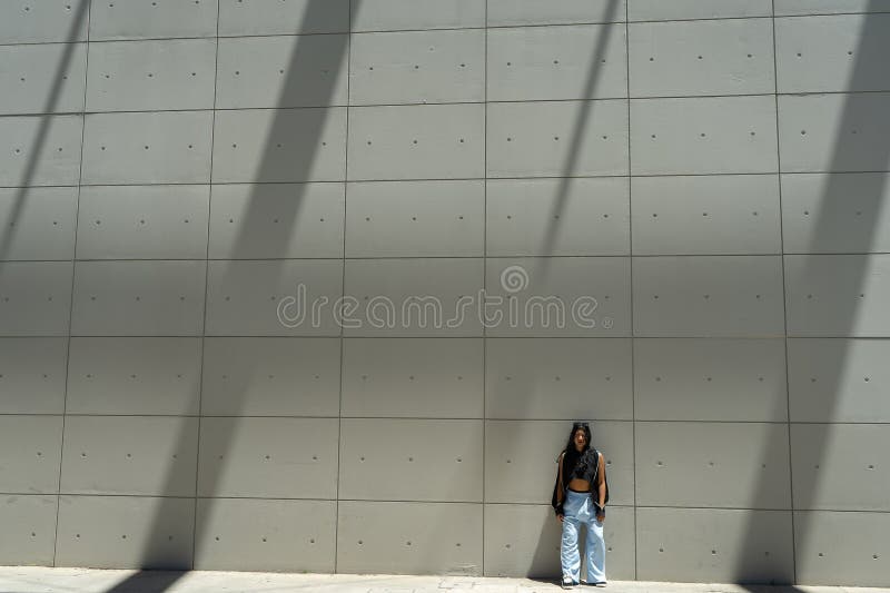 Latin Dancer Posing Against Modern Wall with Geometric Shadows Stock ...