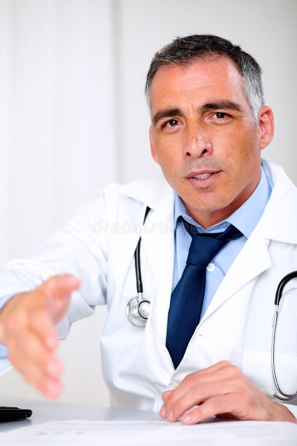 Latin Doctor Greeting at the Consultation Desk Stock Photo - Image of ...