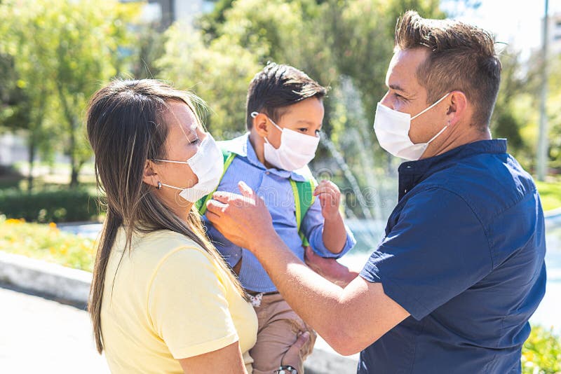 Family with Father, Mother, Son and Daughter Wearing Face Mask Sitting ...