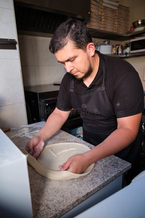 Latin Man Preparing Dough for Pizza in a Restaurant Kitchen. Stock ...