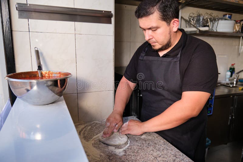 Latin Man Preparing Dough for Pizza in a Restaurant Kitchen. Stock ...