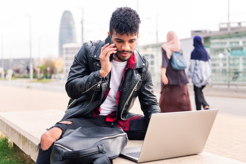 Latin Man Typing on Computer and Talking on Phone Stock Image - Image ...