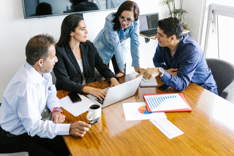 Latin Office Workers Sitting Working Online with Digital Devices in ...