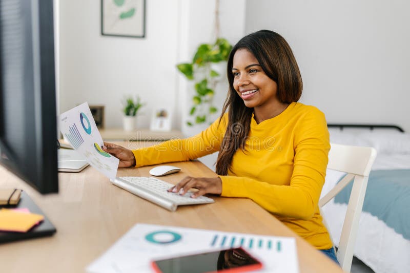 Latin Young College Student with Holding Documents while Using Desktop ...